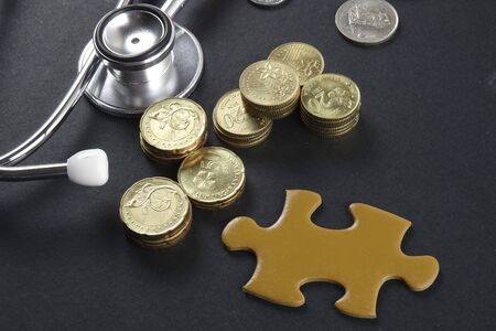 Red stethoscope,coin and puzzle on black. Medical concept. - Stock ...