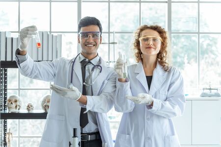 Young successful scientist performing an experiment in modern chemical ...