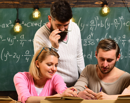 Group Of Students Collaborating On Project In Classroom together ...