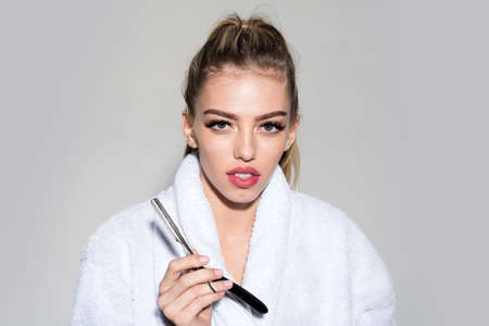 Woman with attractive lips holds straight razor in hand. Barbershop ...
