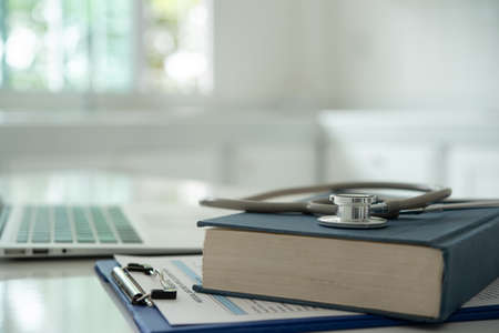 stethoscope on medical guide book for doctor learning treatment at ...