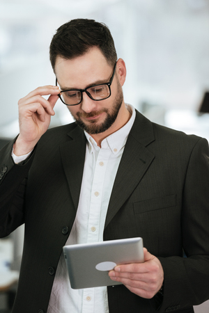 Vertical image of Pensive Bearded business man in suit and eyeglasses ...