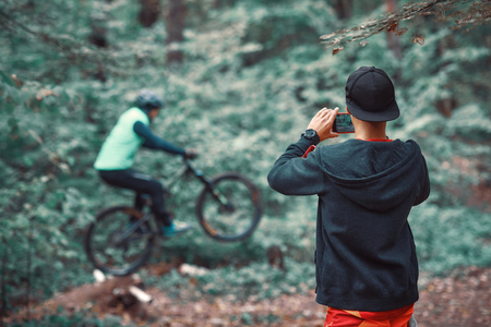 MTB teacher helping rider learn to ride bicycle. Teaching a rider to ...
