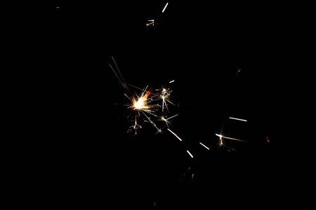 Yellow spark of sparkler on a black background, close up - Stock Image ...