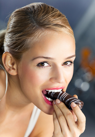 Portrait of young happy woman eating cake at home - Stock Image ...