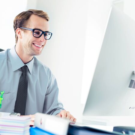 Happy smiling confident businessman in shirt, tie and glasses, working ...