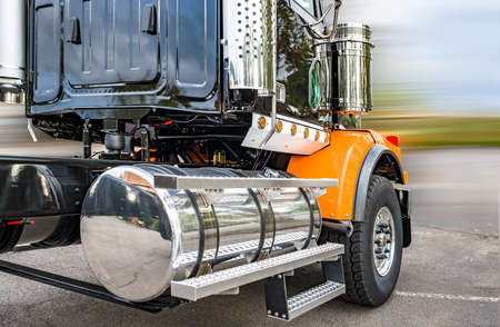 Powerful shiny big rig semi truck tractor in black and orange with ...