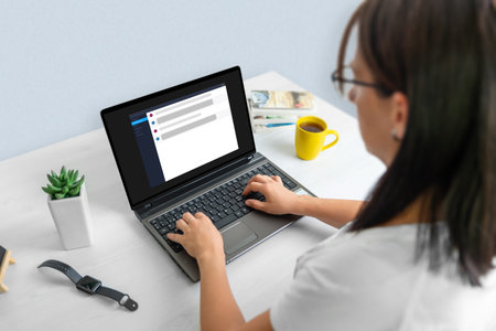 Woman using a laptop computer for work, with an Chat AI interface ...