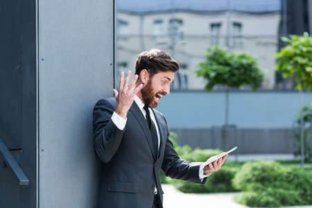 Mad unhappy businessman feeling annoyed using digital tablet smart ...