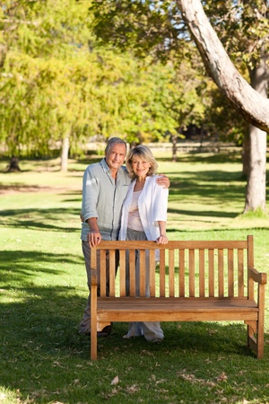 Portrait of a lovely couple behind the bench - Stock Image - Everypixel