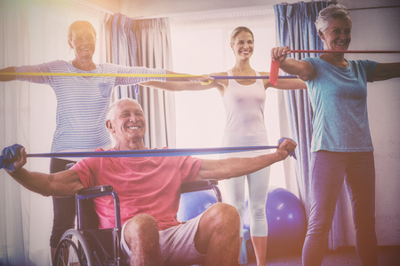 Seniors stretching during fitness class in retirement house - Stock ...