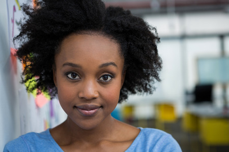 Portrait of female graphic designer smiling in creative office - Stock ...