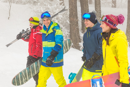 Friends with ski and snow board walking on the snow going to have fun ...