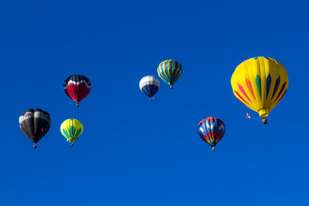 An aerial view of hot air balloons in the bright sky in Albuquerque ...
