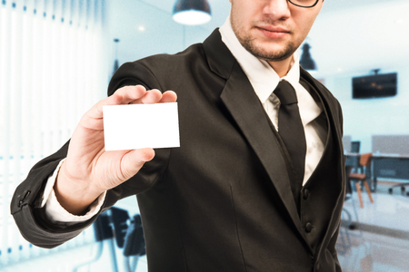 man handing a blank business card at conference room in modern office ...