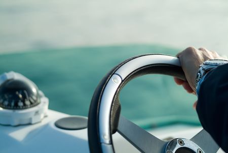 a hand with a steering wheel rudderの写真素材 [40002434275] - イメージマート