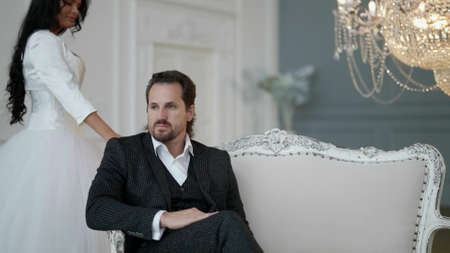 wedding day, man and his beautiful bride in luxury apartment, preparing ...