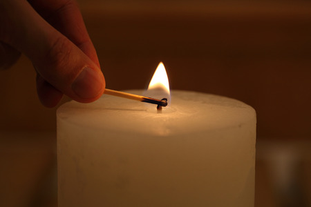 hand with a match lights a candle - Stock Image - Everypixel