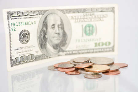 Numerous coins against one hundred dollar bill. You must save every ...