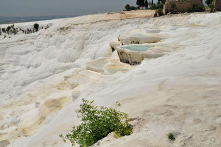 A natural purely white wall of calcium in Pamukkale, a natural site and ...