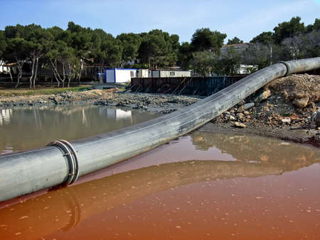 Pipe dumping wastewater on the sea - Stock Image - Everypixel