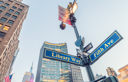 Library way and Fifth avenue street signs in New York City. - Stock ...