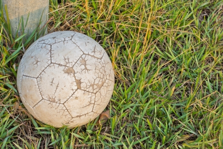 Old Soccer Ball. Poor school soccer field. - Stock Image - Everypixel