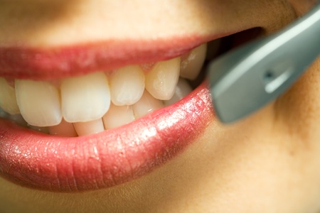 Close-up (mouth) of a friendly female call center operator; very ...