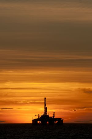 Oil rig in offshore area during sunset time. - Stock Image - Everypixel