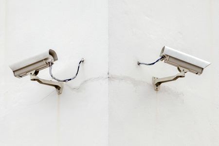 Security cameras, Two CCTV on the cone of the white building corner for ...