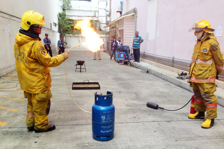 A firefighters is demonstrating about gasoline burning which come from ...