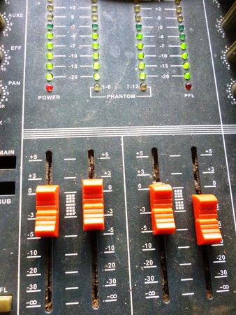 Side closeup on a sliders of a mixing console. It is used for audio ...