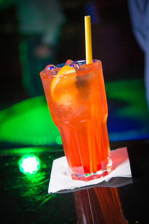 an alcoholic orange cocktail is in beautiful glass, on the bar - Stock ...