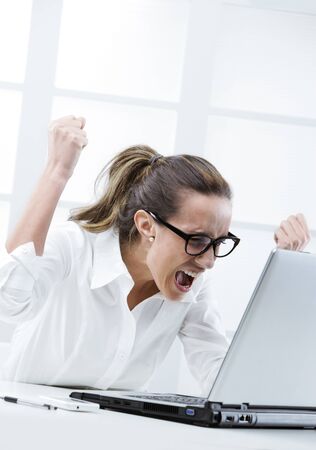 Freaked out businesswoman ready to smash her laptop computer - Stock ...