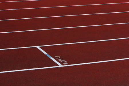 multiple lanes on a red running track with white divindg lines, 4x400m ...
