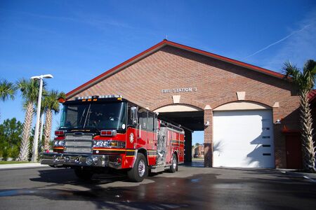 Red and black fire engine parked in front of Fire Station number 3 ...