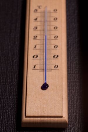 Old thermometer measuring in celsius. On the black wall. - Stock Image ...