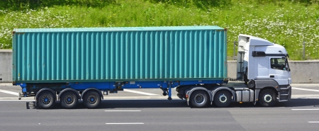 Shipping container on articulated trailer and lorry on UK motorway ...