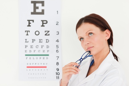 A female optician with eye test in her office - Stock Image - Everypixel